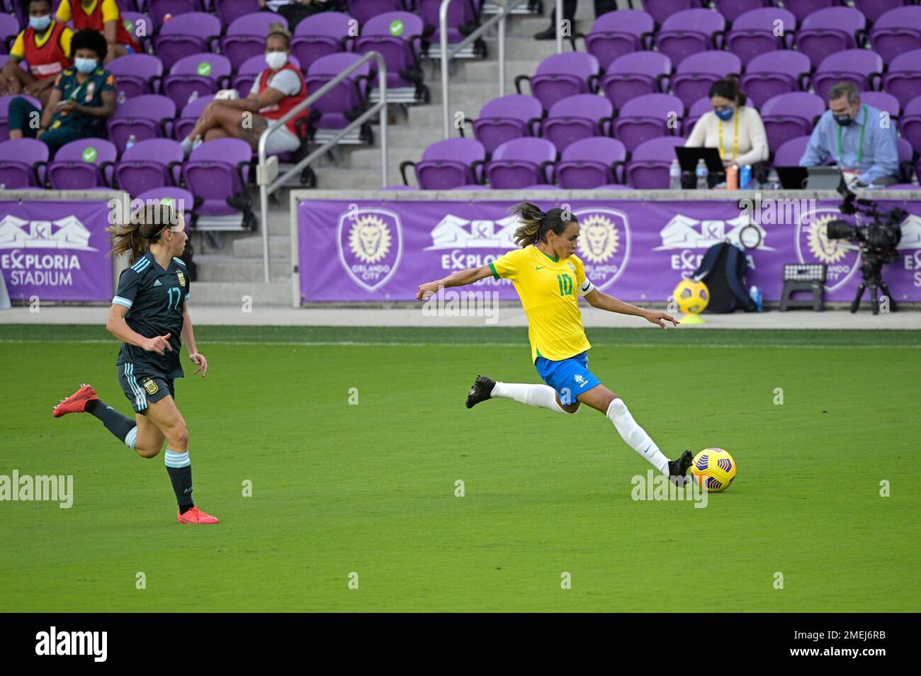 Brazil midfielder Marta (10) kicks a ball in front of Argentina ...