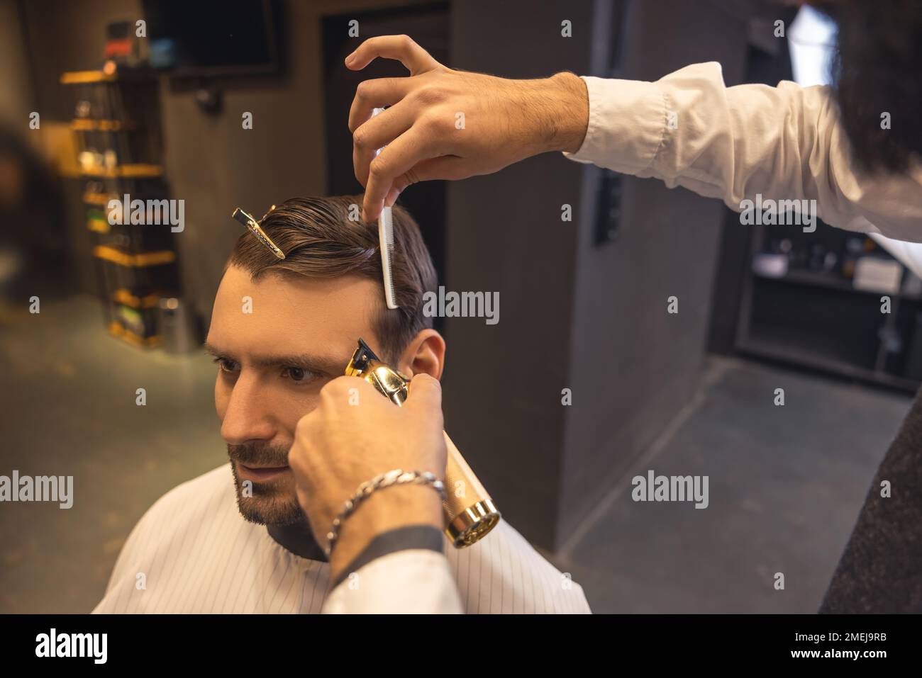Barber trimming clients hair hi-res stock photography and images - Alamy