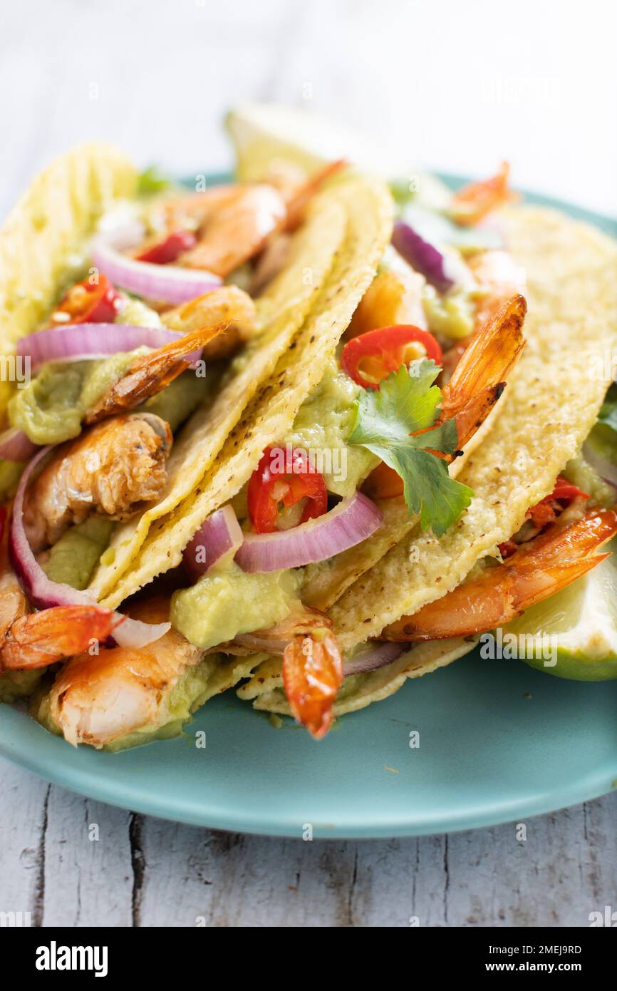 Mexican tacos with shrimp,guacamole and vegetables on wooden table ...
