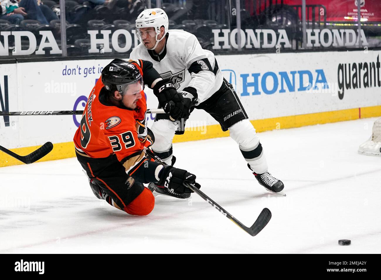 Anaheim Ducks center Sam Carrick, left, is shoved down by Los Angeles ...
