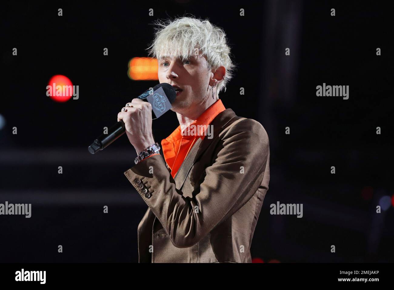 Machine Gun Kelly addresses the crowd during the 2nd round of the NFL ...
