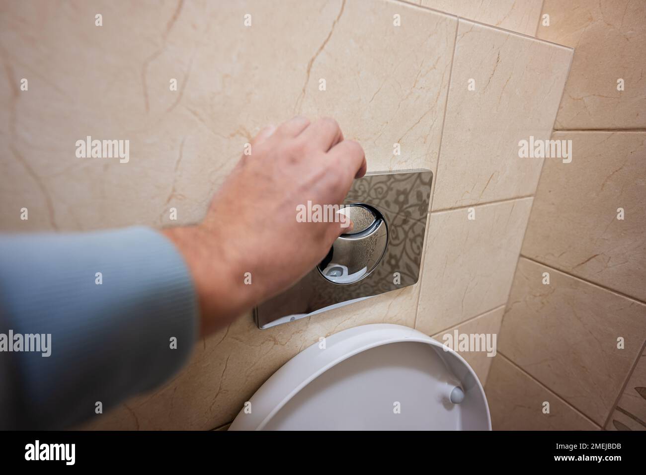 Hand of man push toilet flush press with two separate buttons Stock ...