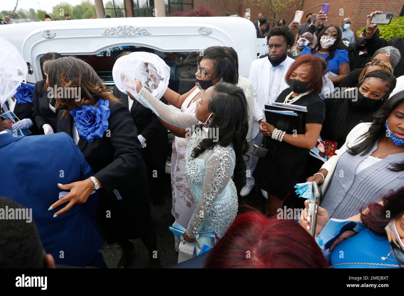 Paula Bryant, top, center, releases butterflies in honor of her ...