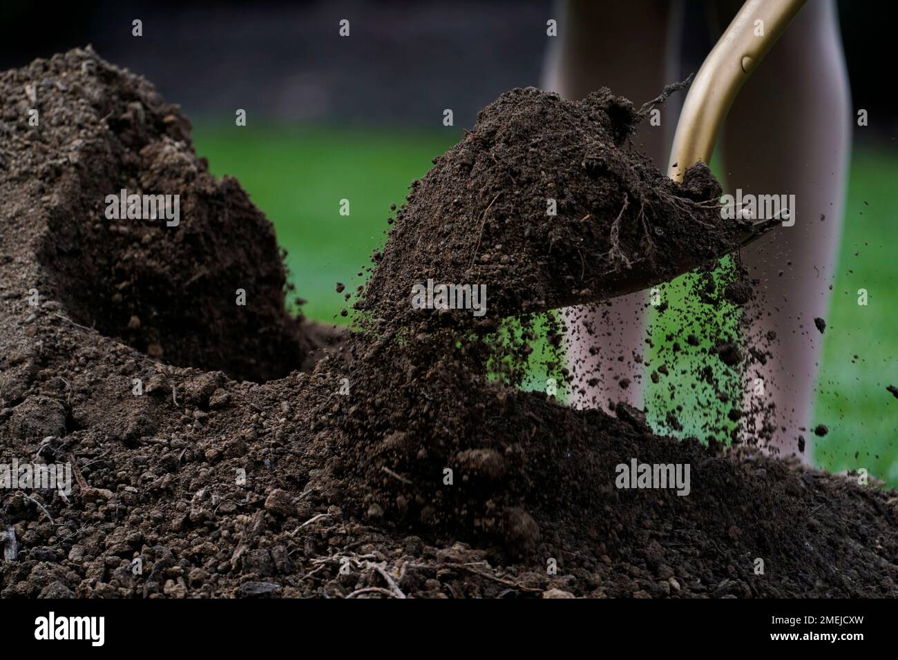 First lady Jill Biden uses a shovel as she participates in an Arbor Day ...