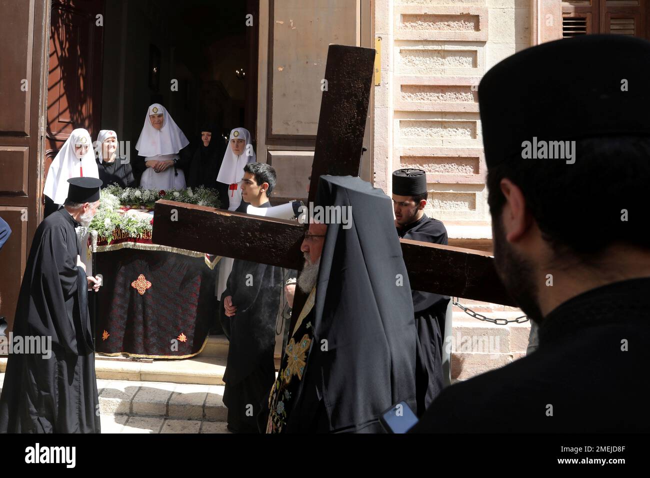 Greek Orthodox clergy walk along the Via Dolorosa during the Good ...
