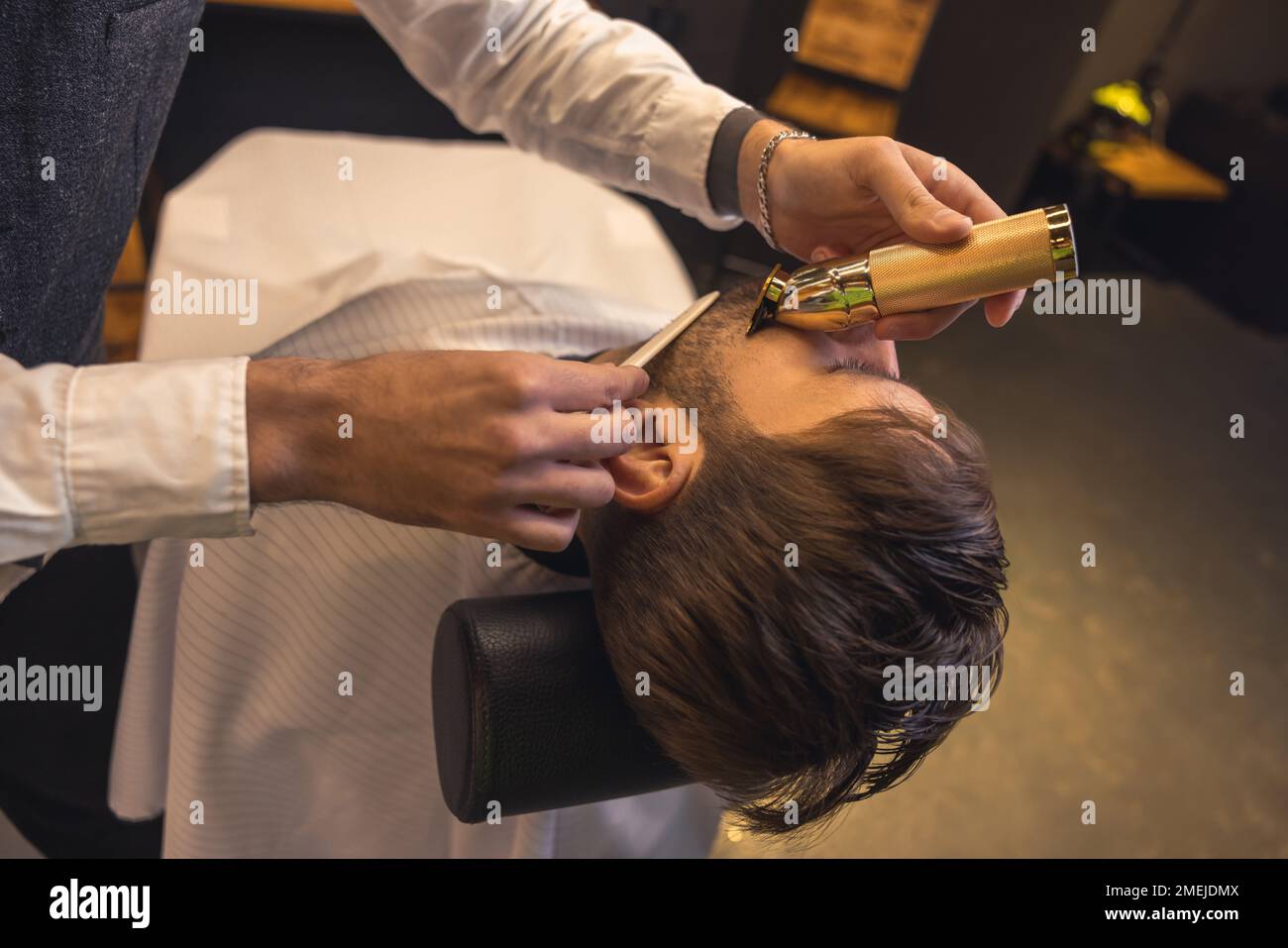Professional barber carefully trimming the clients beard Stock Photo - Alamy