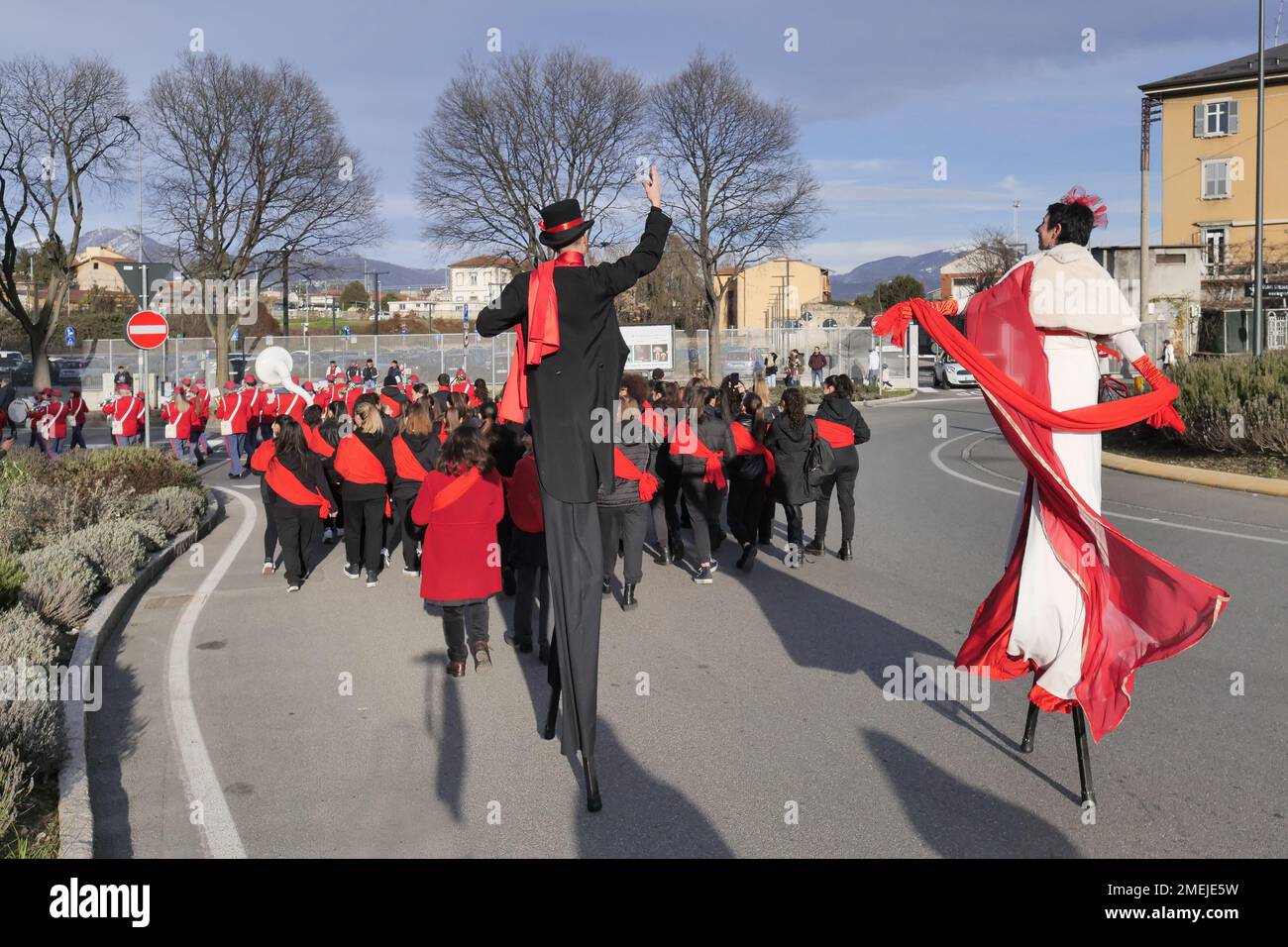 Acrobats and stilt walkers parade through the streets of the city to ...