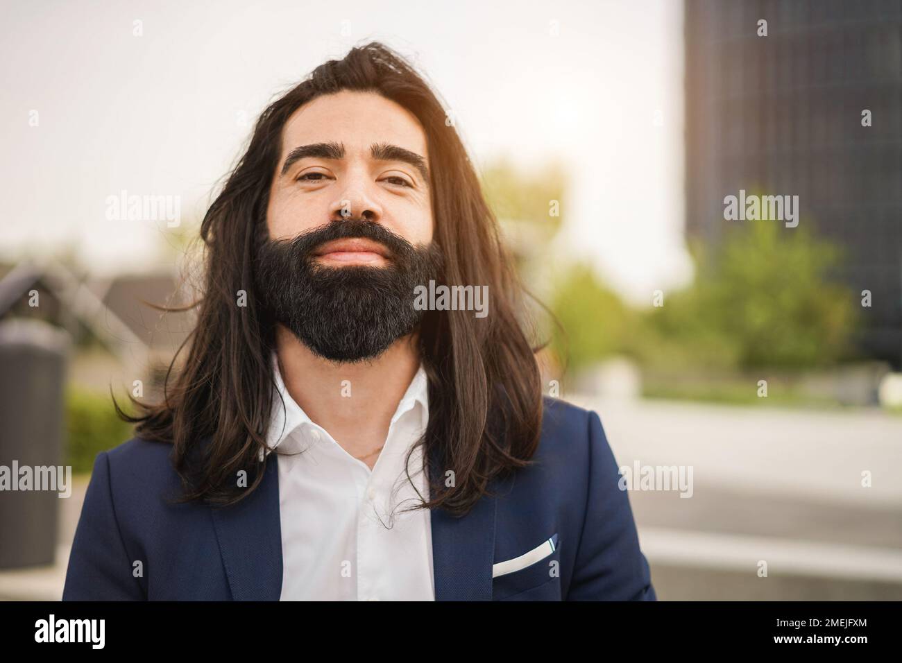Young business man working outside of the office with city in ...