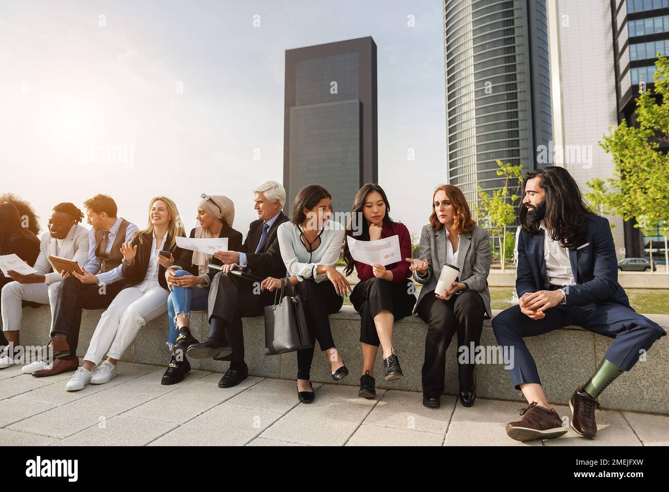 Multiracial business people working outdoor from office building ...