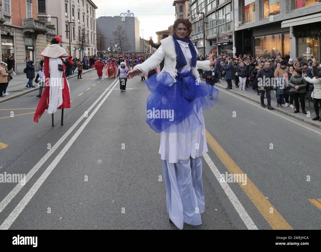 Acrobats and stilt walkers parade through the streets of the city to ...