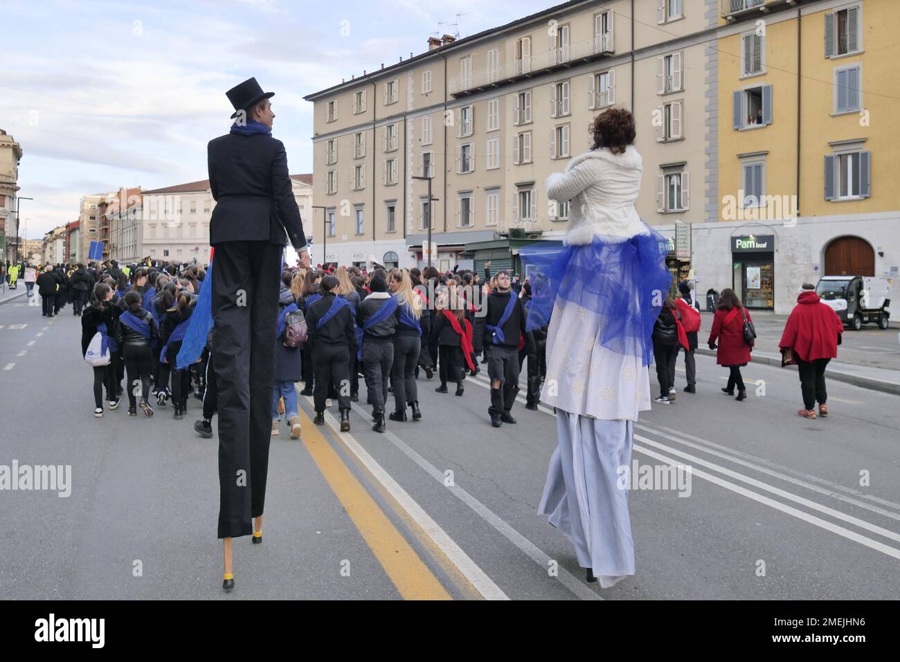 Acrobats and stilt walkers parade through the streets of the city to ...
