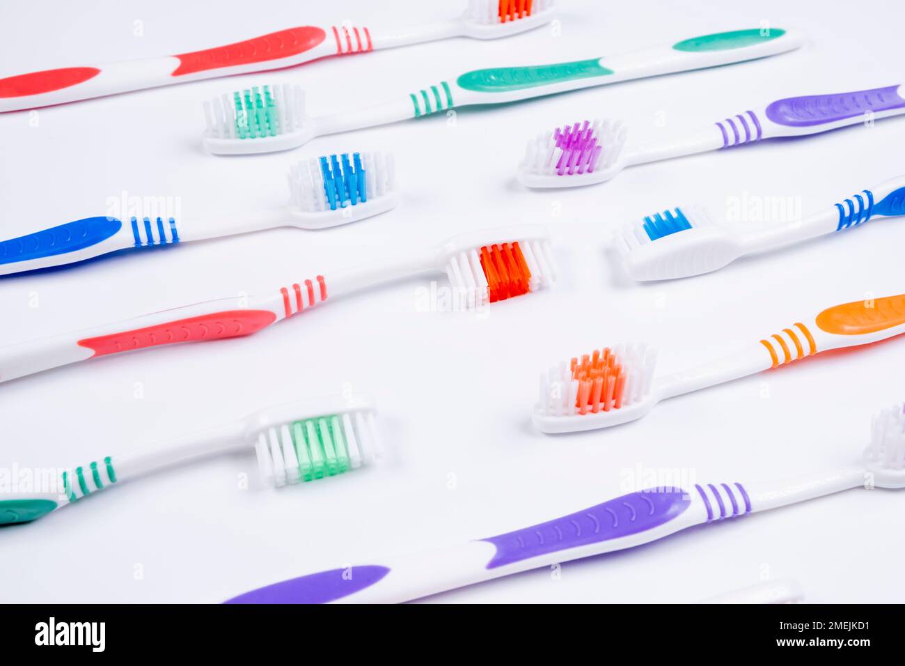 background dental toothbrushes of different colors on a white ...
