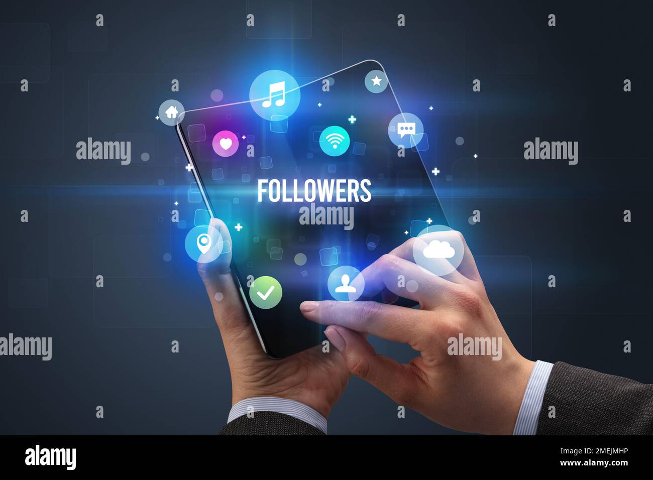 Businessman holding a foldable smartphone Stock Photo - Alamy