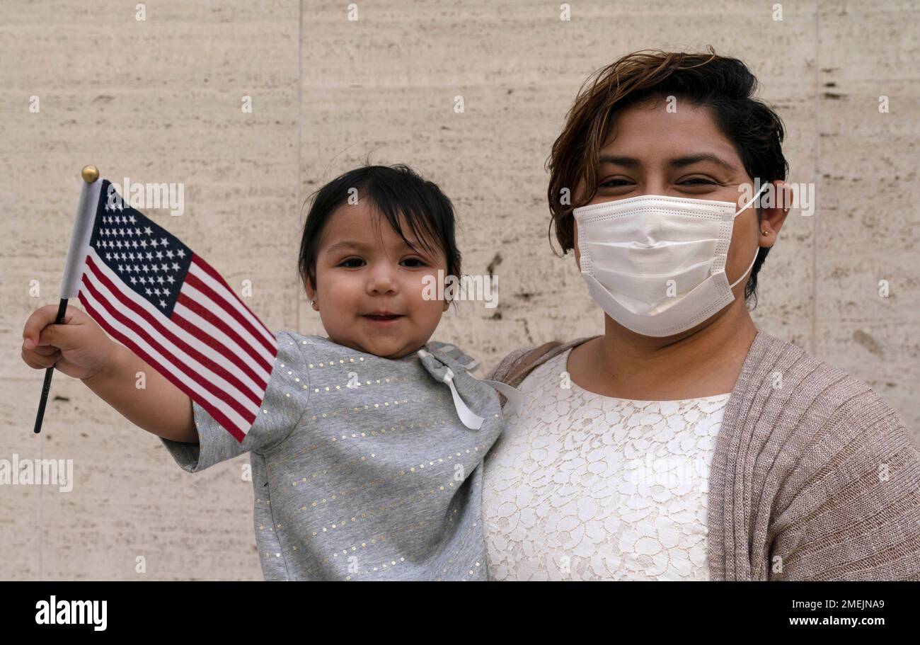 One-year-old Emily Reyes holds a United States flag after her mother ...