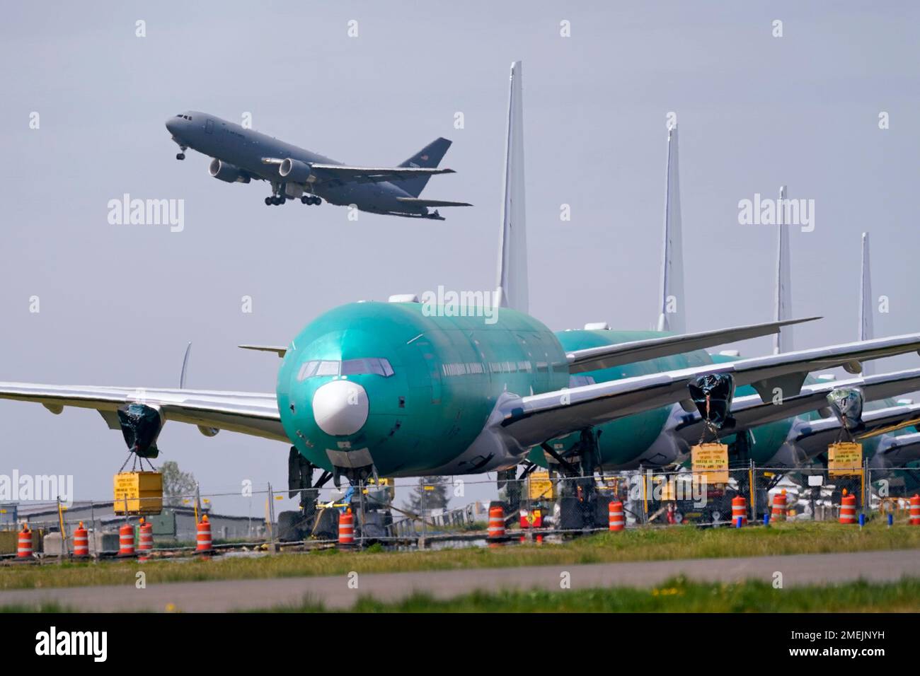 A U.S. Air Force KC-46A Pegasus jet takes off in view of a line of ...