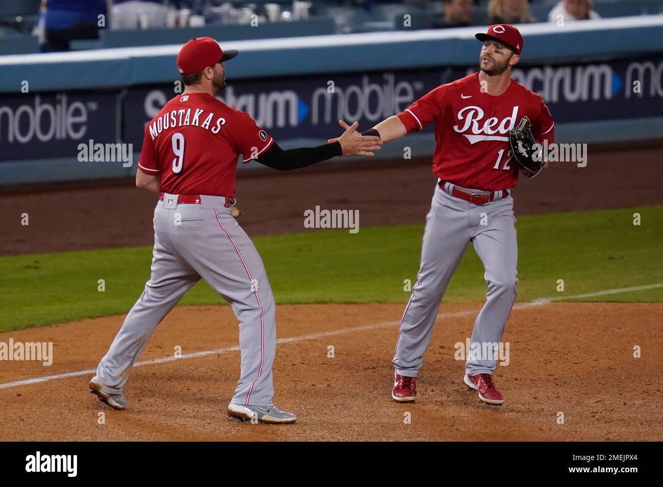 Cincinnati Reds third baseman Mike Moustakas (9) high-fives right ...