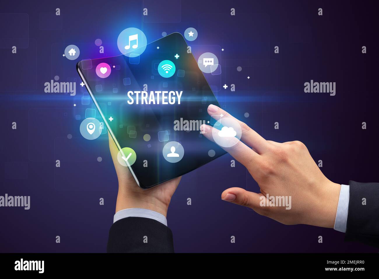 Businessman holding a foldable smartphone Stock Photo - Alamy