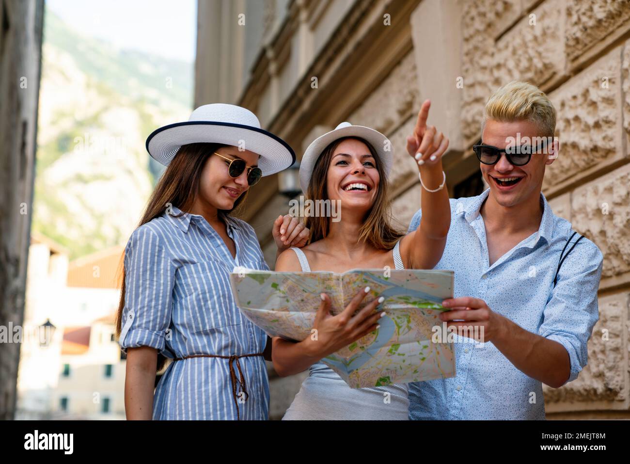 Happy group of young friends enjoying sightseeing tour in the city on ...