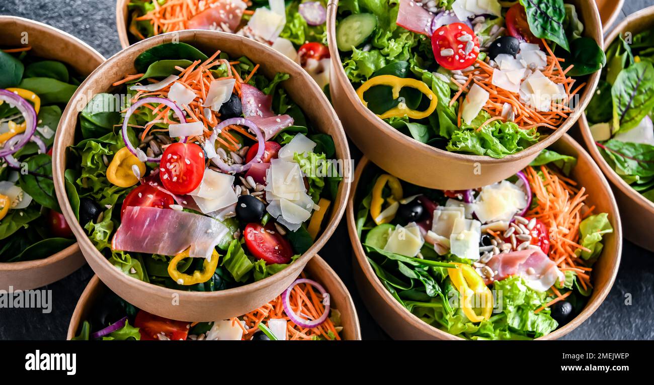 Round paper boxes with pre-packaged vegetable salads ready for sale ...