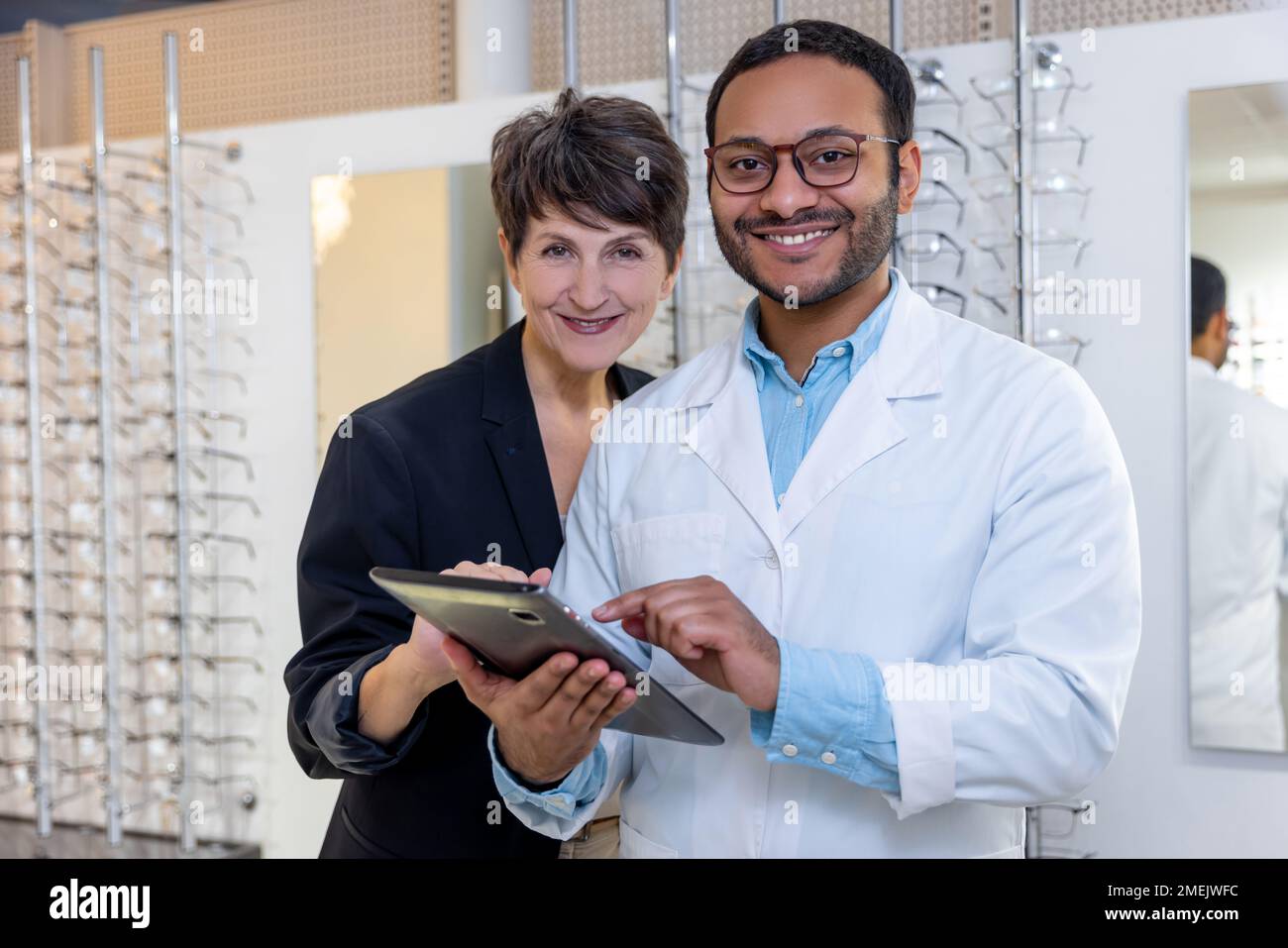 Male optometrist helping woman hi-res stock photography and images - Alamy