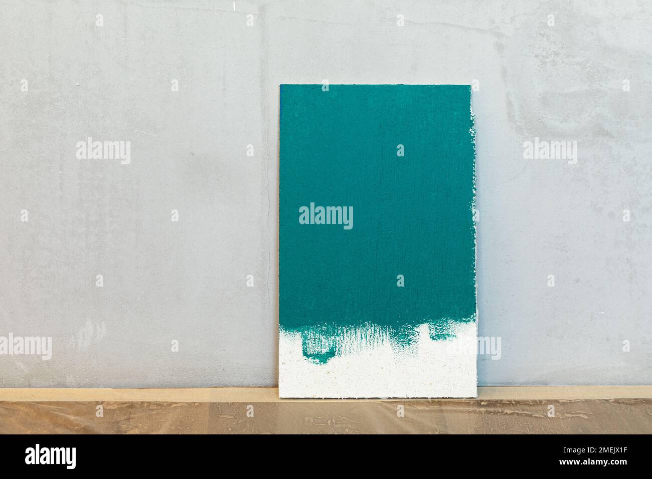 Green color sampler at blank gypsum plaster wall - interior renovation ...