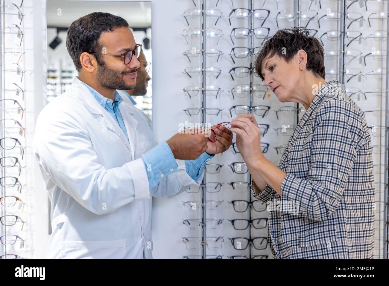 Male optometrist helping woman hi-res stock photography and images - Alamy