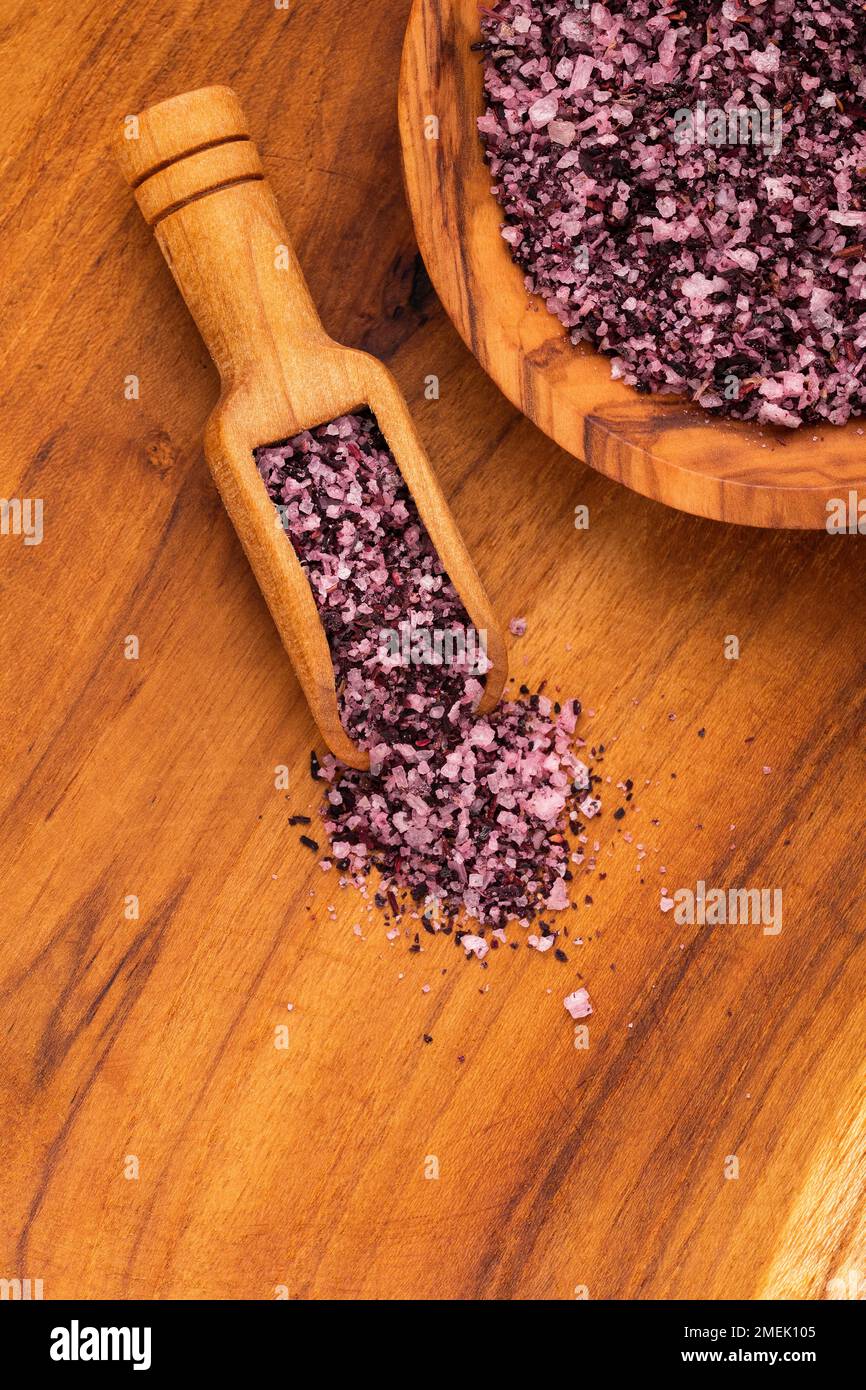 Natural hibiscus salt in wooden spoon - fine crystals for seasoning ...