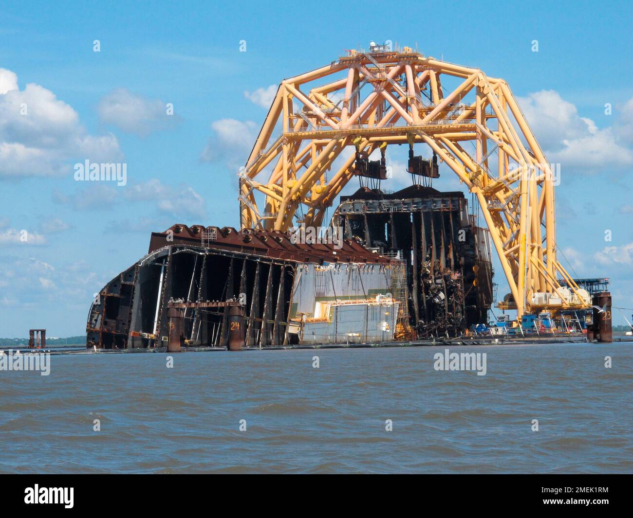 A towering crane pulls the engine room section away from the remains of ...