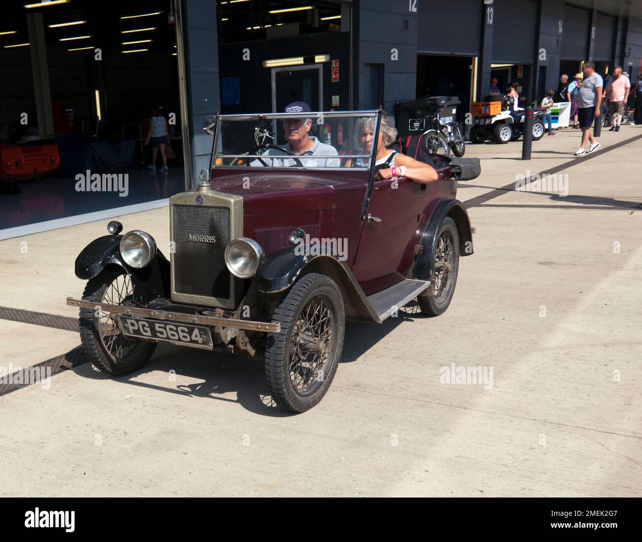 A Red, 1930, Morris Minor Tourer, being driven down the International ...