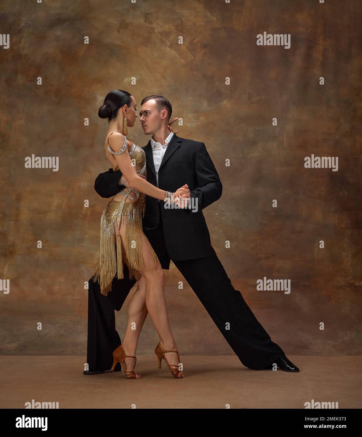 Deep, impressive look. Man and woman, professional tango dancers in stylish, beautiful stage ...