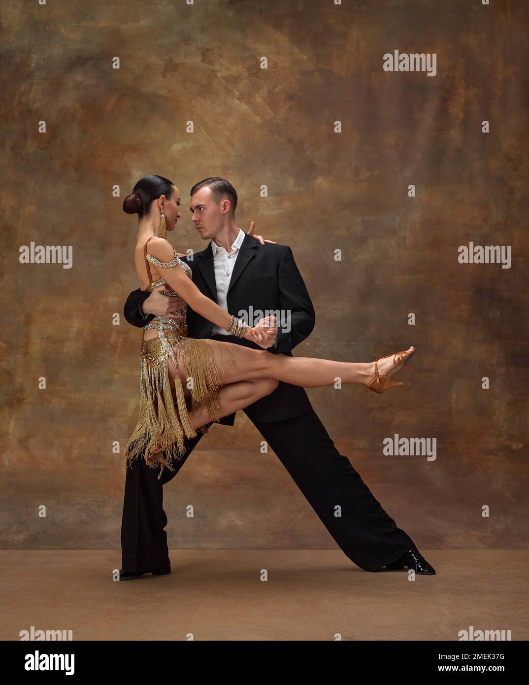 Sensual pose, attentive look. Man and woman, professional tango dancers in stylish, beautiful ...
