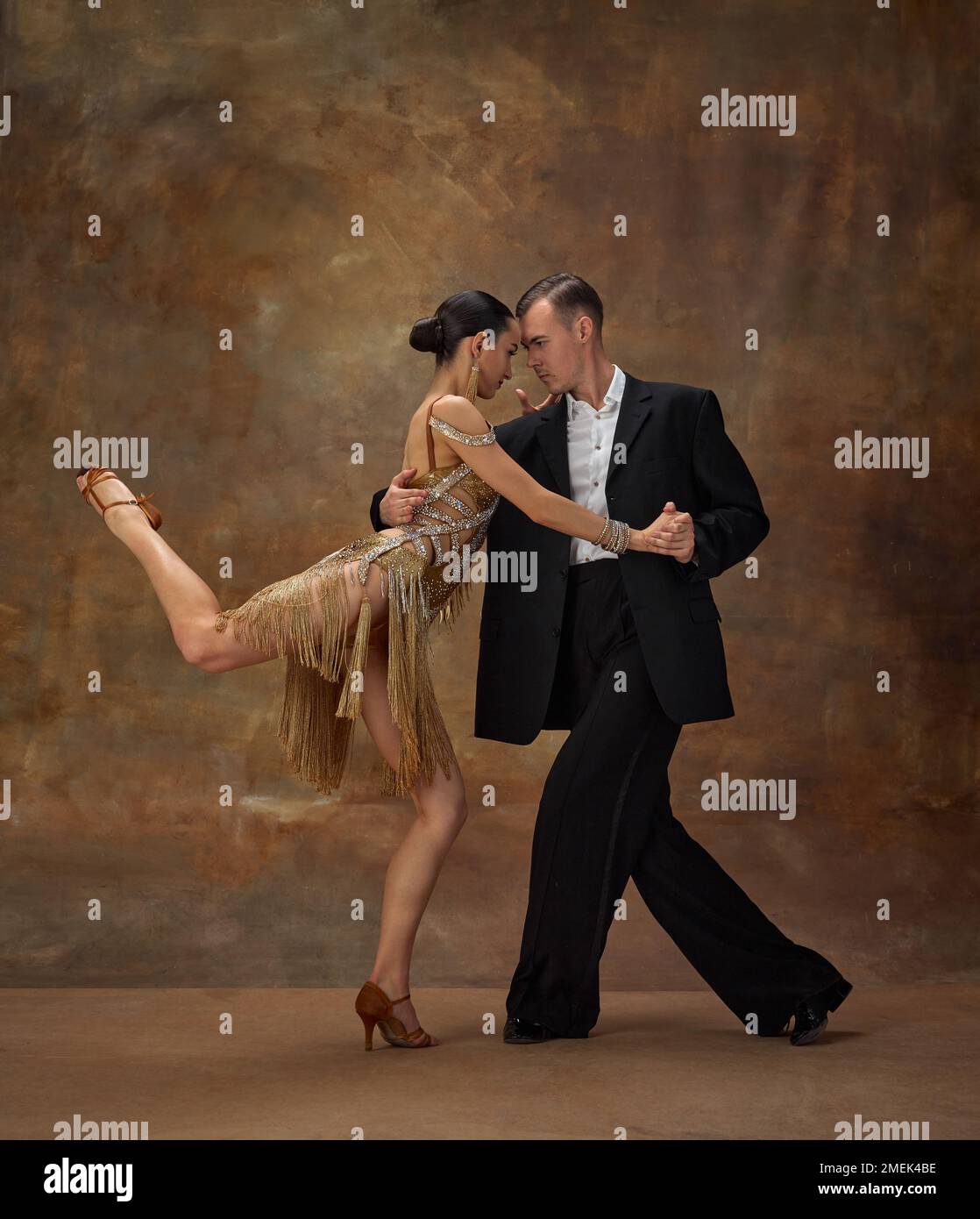 Partner, couple dance. Man and woman, professional tango dancers in stylish, beautiful stage ...