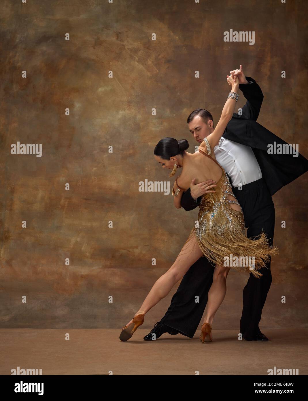 Man and woman, professional tango dancers in stylish stage costumes ...