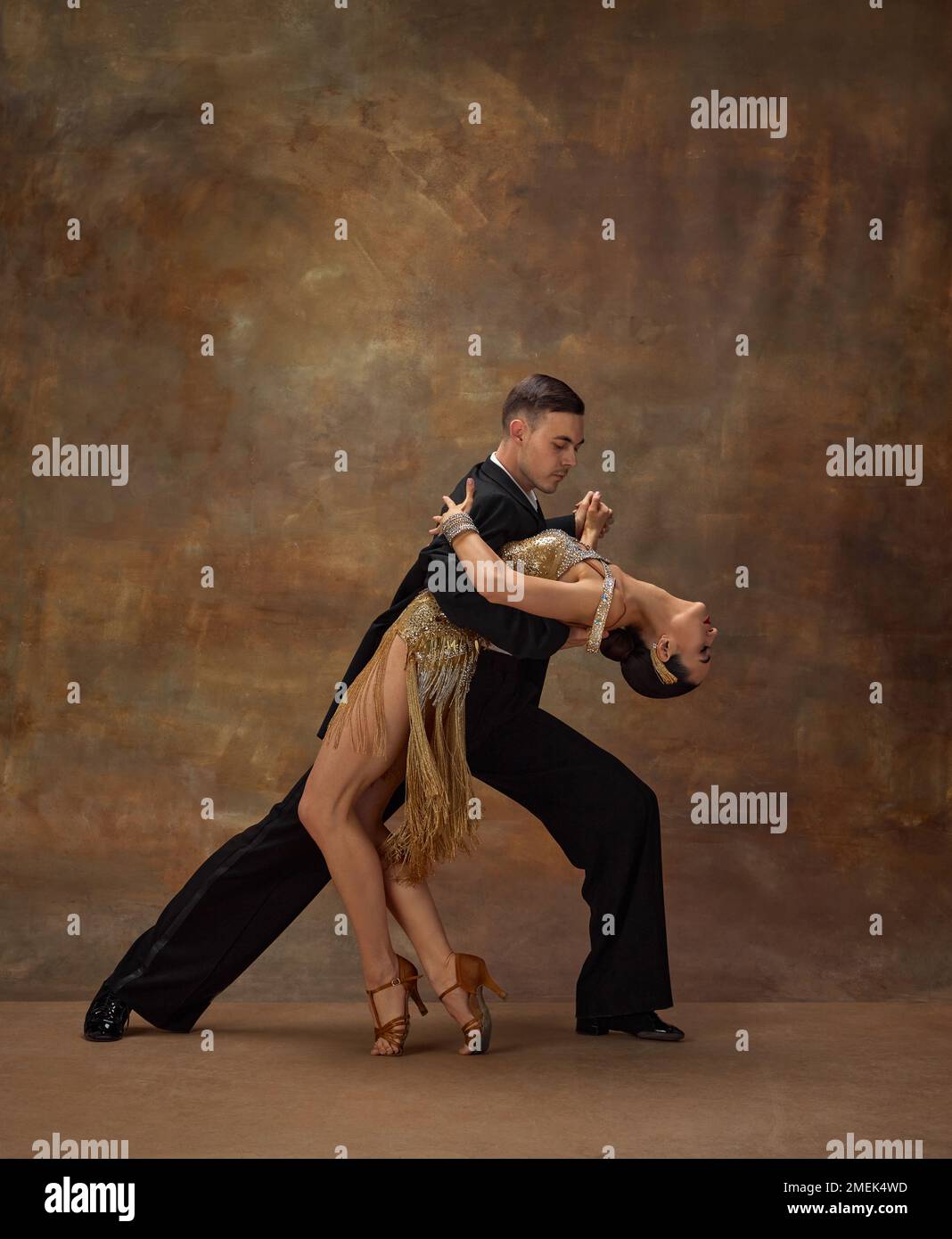 Passion, emotions. Man and woman, professional tango dancers in stylish, beautiful stage ...