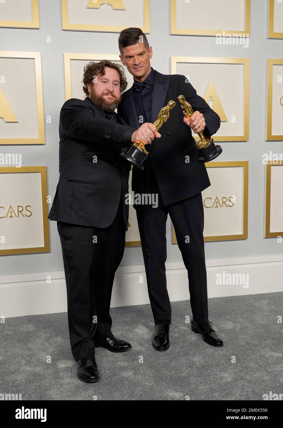 Michael Govier, left, and Will McCormack pose in the press room with ...