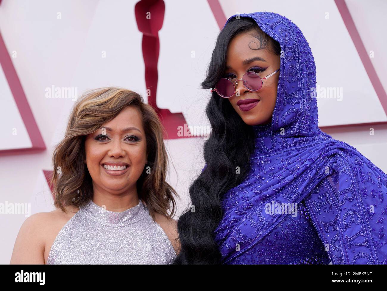 Agnes Wilson, left, and H.E.R. arrive at the Oscars on Sunday, April 25 ...