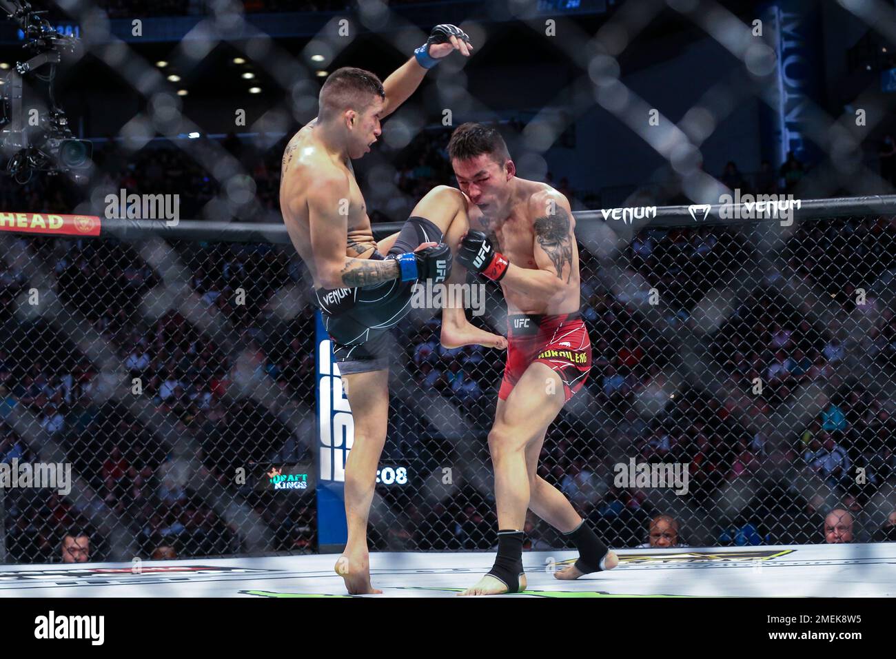 Aoriqileng takes a knee to the face from Jeffrey Molina during a UFC ...