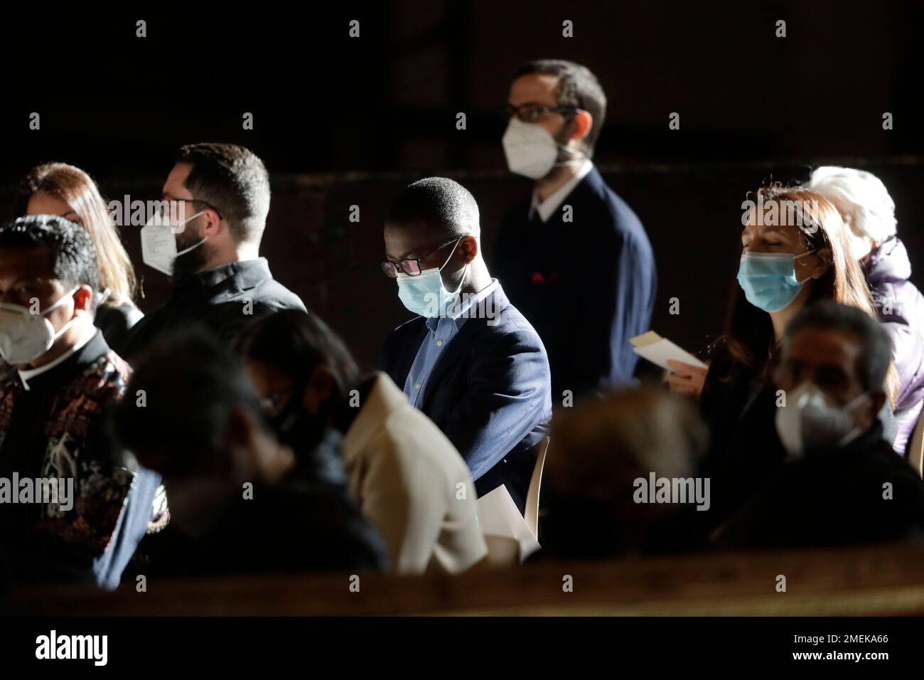 Faithful wear face masks to curb the spread of COVID-19 as they wait ...