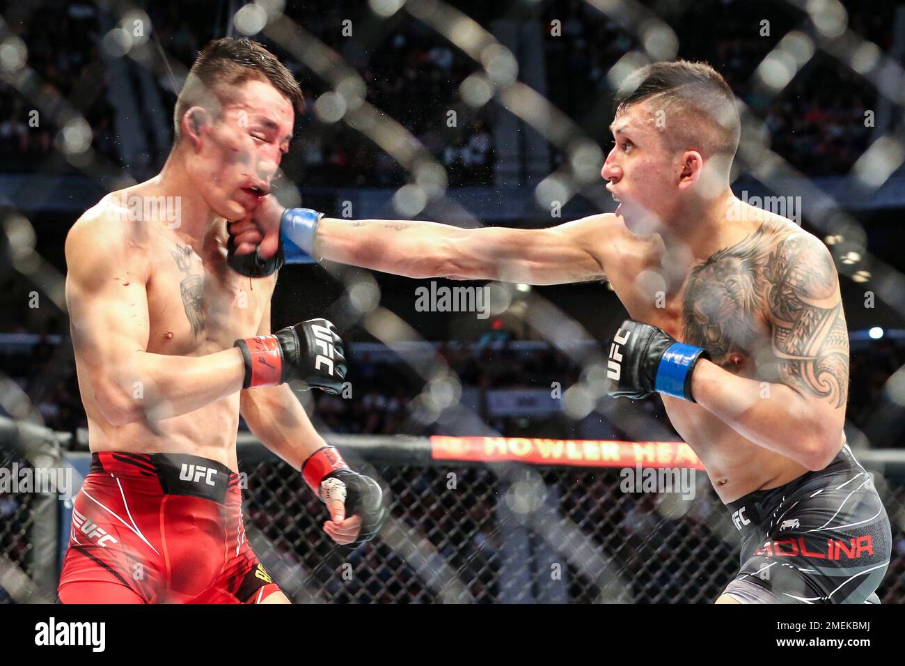 Aoriqileng, left, takes a punch from Jeffrey Molina during a UFC 261 ...
