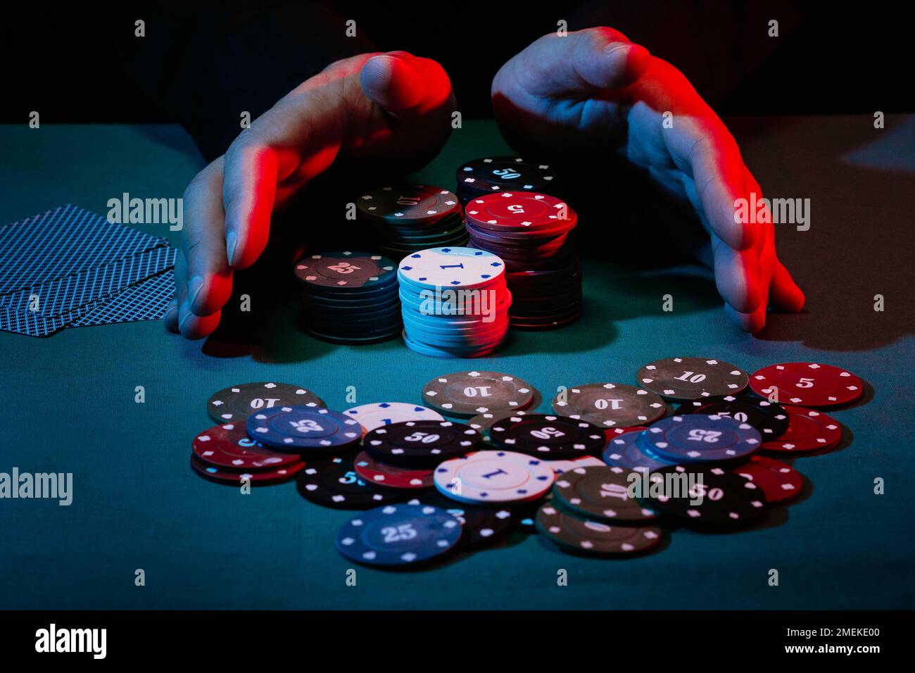 men's hands place bet with playing chips Stock Photo - Alamy