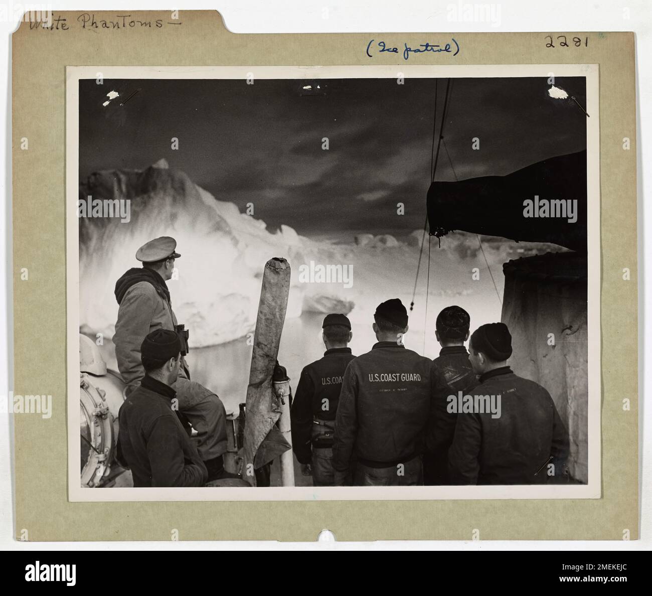 Coast Guardsmen aboard a combat cutter watch as an iceberg floats by in ...