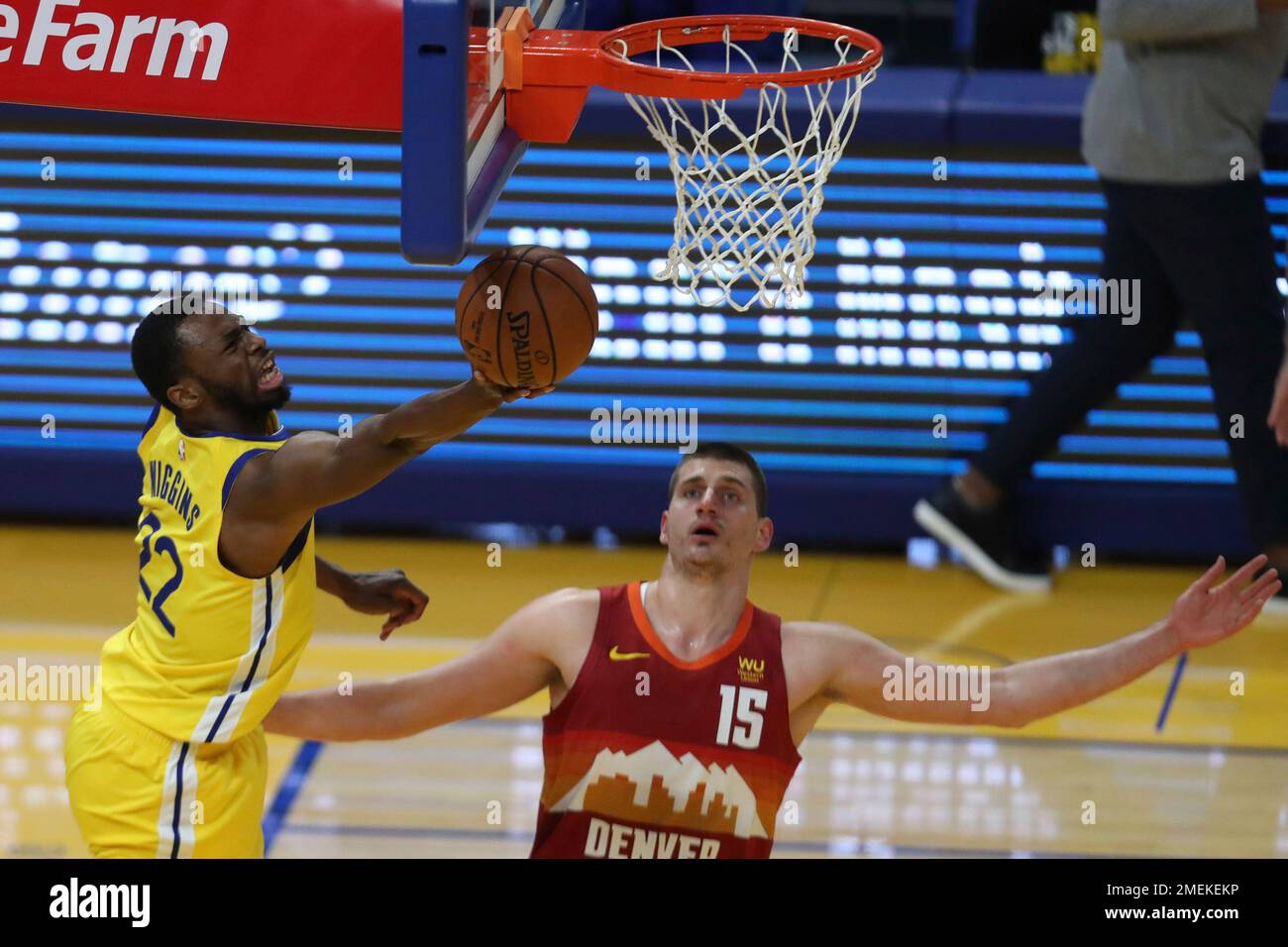 Golden State Warriors' Andrew Wiggins, left, shoots against Denver ...