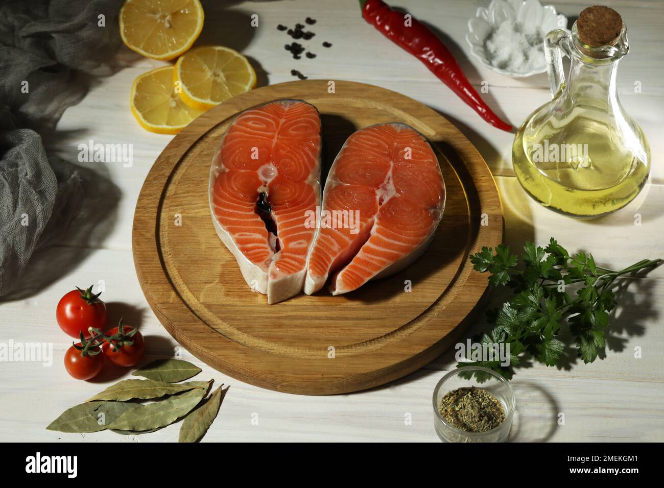 Fresh salmon steak with ingredients on white wooden background Stock ...