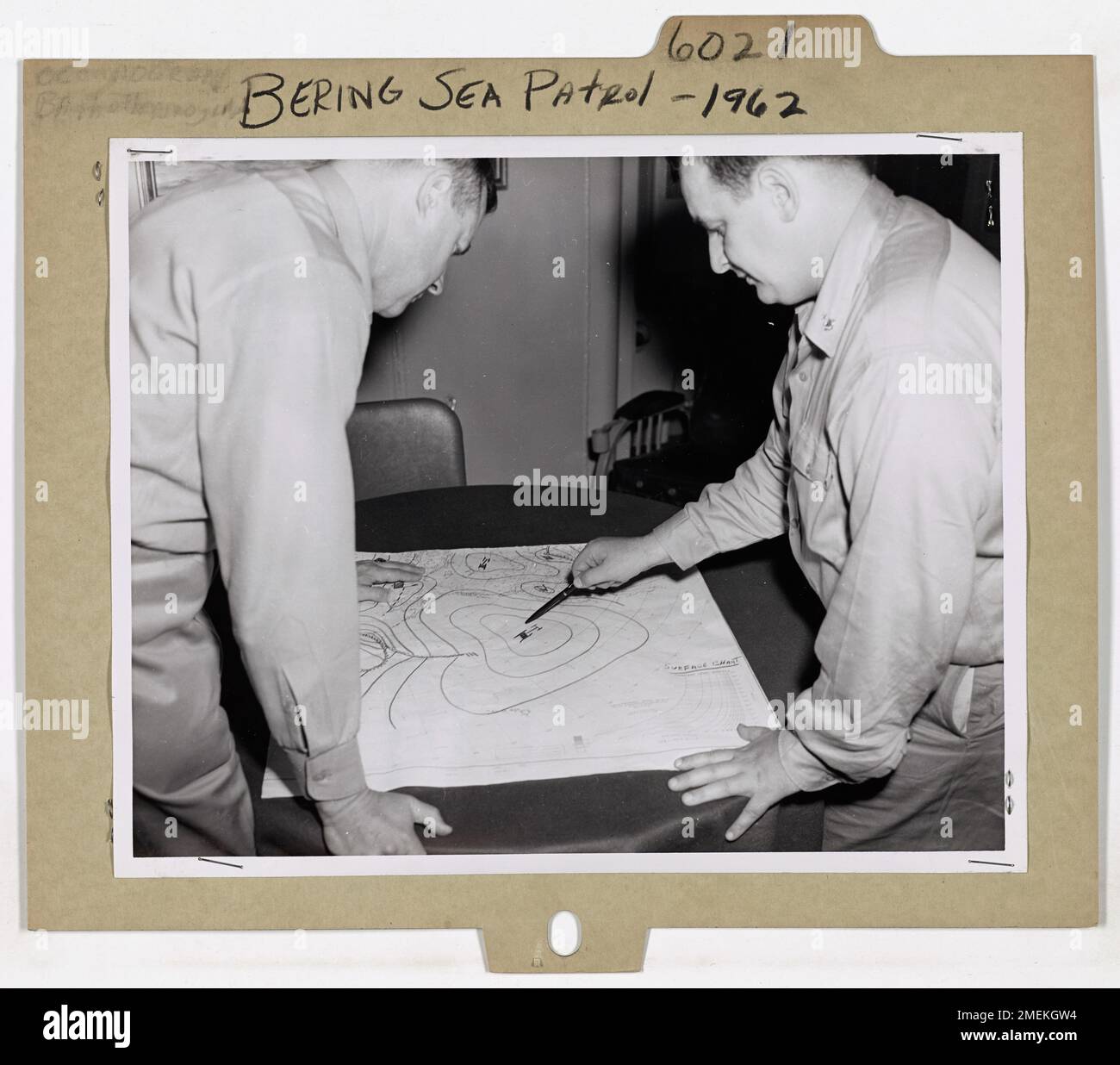 Captain R.R. Waesche, USCG, receives a weather briefing from ...