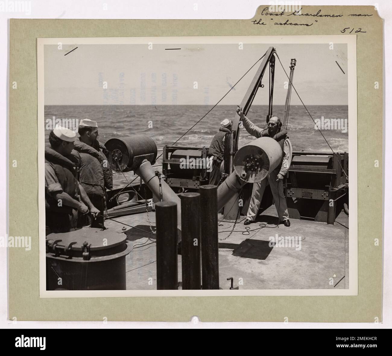 Coast Guardsmen aboard an Atlantic cutter prepare to deploy ash cans, a ...