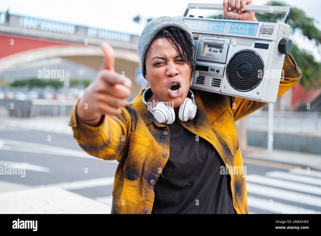 Young woman with dreadlocked hair rapping directly into the camera with ...