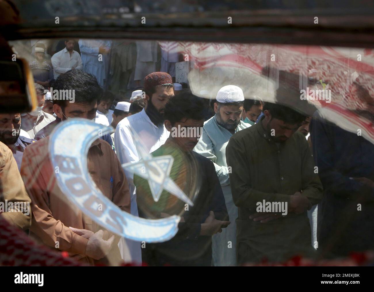 Muslims are seen though a windscreen of a auto rickshaw while ...