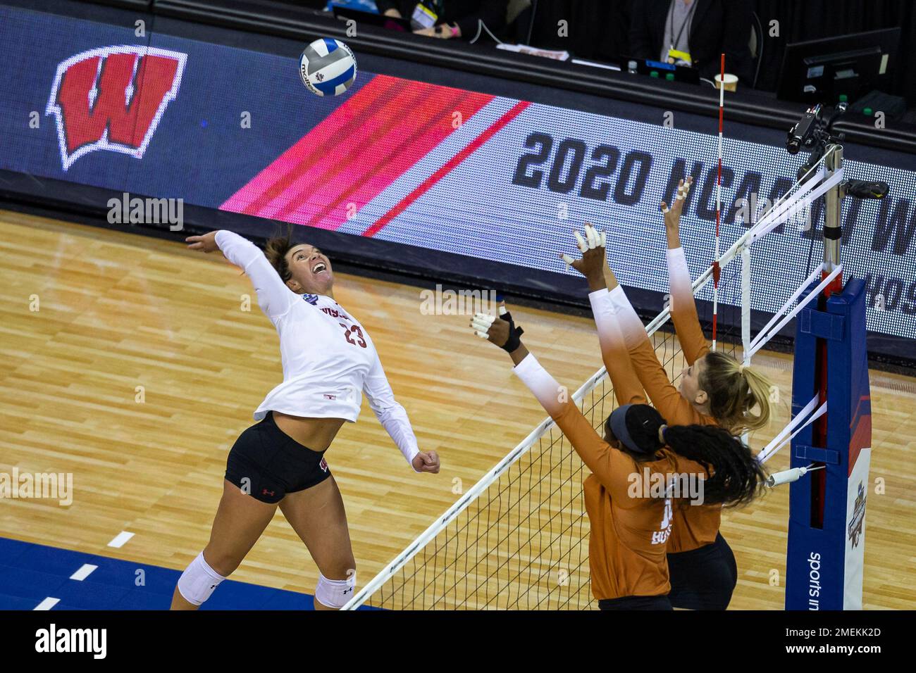 Wisconsin's Molly Haggerty (23) spikes the ball against Texas' Brionne ...