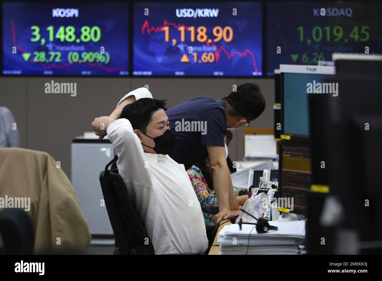 A currency trader watches monitors at the foreign exchange dealing room of the KEB Hana Bank ...