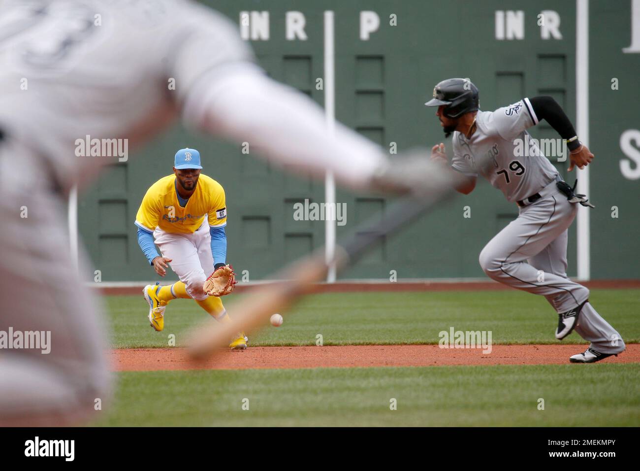 Boston Red Sox shortstop Xander Bogaerts, background left, fields a ...